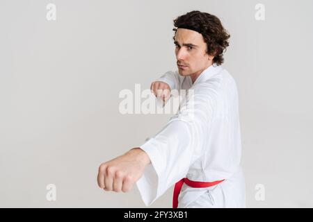 Karate man exercising isolated against white background Stock Photo - Alamy