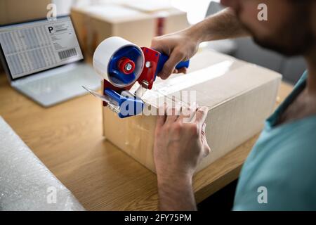 Person Packaging Parcels For Online Delivery To Customers Stock Photo ...