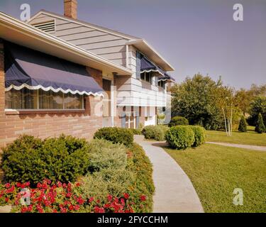 1960s SPLIT LEVEL SUBURBAN HOUSE WITH SOLD SIGN IN FRONT YARD - b22878 ...