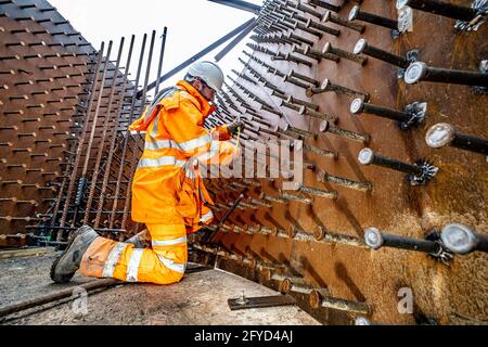 Construction workers in action on construction site Stock Photo - Alamy