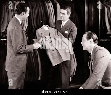 1930s TWO MEN CLERK AND CUSTOMER TALKING OVER COUNTER IN RETAIL GENERAL ...