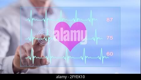 Man touching a heart beats graph on a touch screen with his finger ...