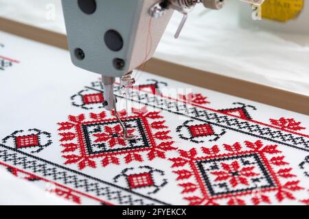 Cross stitch on a sewing machine, close up, selective focus Stock Photo ...