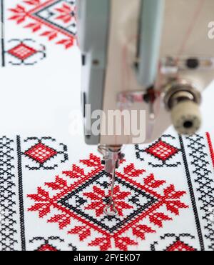 Cross stitch on a sewing machine, close up, selective focus Stock Photo ...