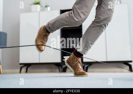 Wire Cord Trip Over And Fall. Feet Stumble Stock Photo - Alamy