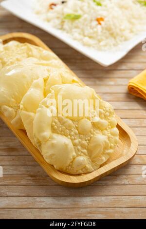 Kerala Papadum or plain pappadom or Appalam ,arranged in a wooden board ...