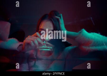 Portrait of a girl sniffing a line of white drug cocaine powder. Addict ...