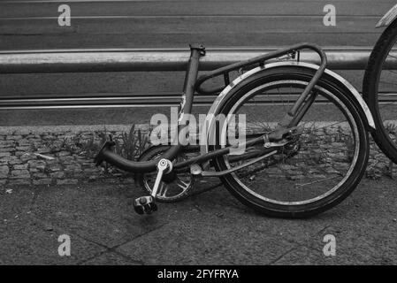 An old junk bike attached to a railing, old junk bike, a half bike ...