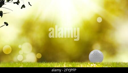 Composition of golf ball in grass on red tee, clouds, and copy space ...