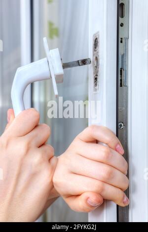 handle on the window with aluminum frame Stock Photo - Alamy