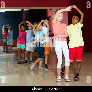 Group of kids dancing salsa dance in modern studio Stock Photo - Alamy
