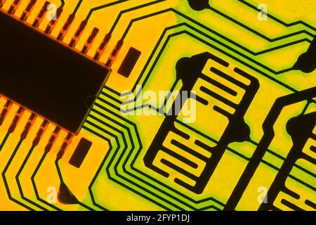 Vibrant coloured abstract macro shot of an opaque printed circuit board ...