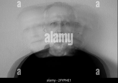 Man with split personalities standing in front of wall Stock Photo - Alamy