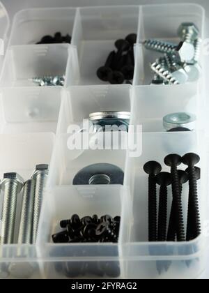 Closeup of various industrial fasteners in the plastic storage ...