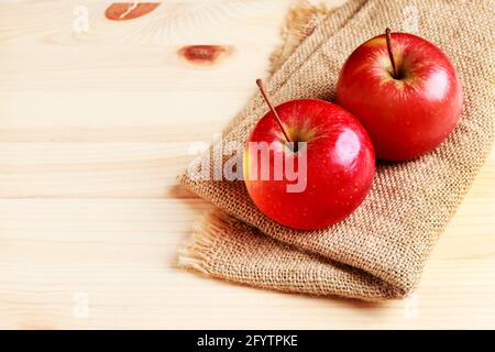 Red apples on jute sack, wooden background. Healthy food Stock Photo ...