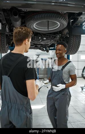 Male mechanics looking on checklist, car service Stock Photo - Alamy