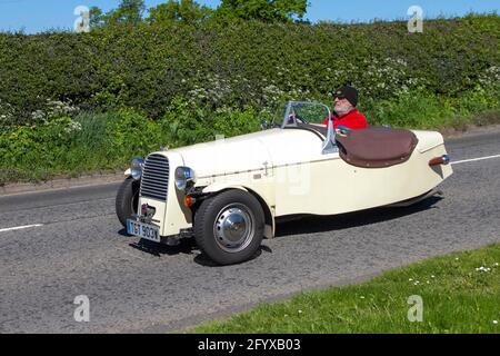 Three-wheeled vehicles on the road, called Tatlong-wiler motorized ...