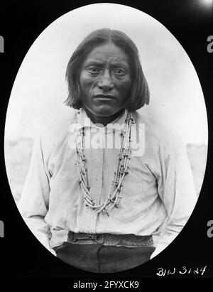 Black and white historical photograph of a Hopi Pueblo woman weaving ...