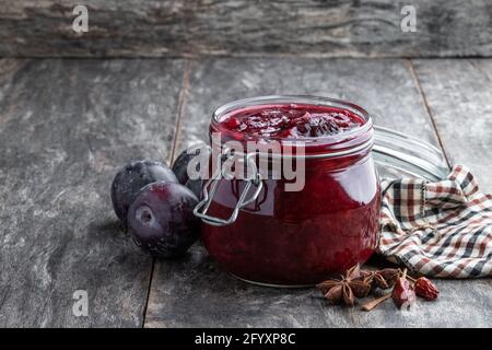 Homemade plum chutney in glass jar on wooden table Stock Photo - Alamy