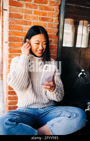 young asian woman having video call consultation waving greeting using ...