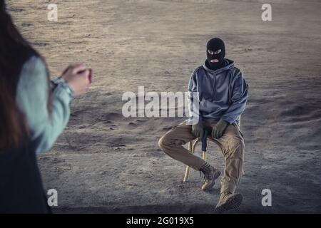 Female hostage sitting on chair against white background Stock Photo ...