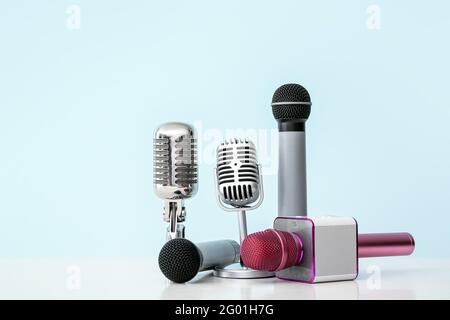 Different microphones on color background Stock Photo - Alamy