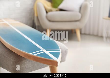 Bench with surfboard in interior of stylish modern room Stock Photo - Alamy