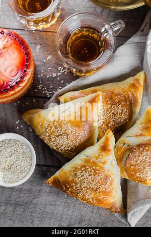 Delicious samosas samsa with meat, glass of tea on wooden table ...