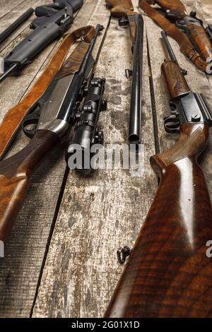 Many hunting rifles on weathered wooden surface Stock Photo - Alamy