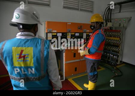 Officers (state electricity company) PLN carry out maintenance of a 20 ...