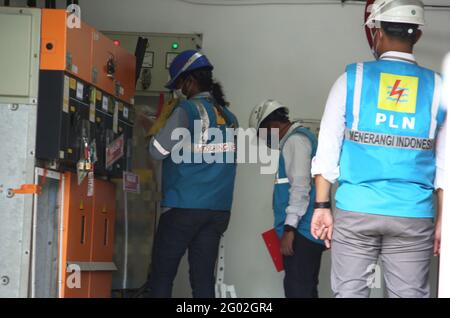 Officers (state electricity company) PLN carry out maintenance of a 20 ...