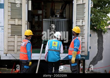 Officers (state electricity company) PLN carry out maintenance of a 20 ...
