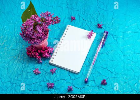 Notebook with pen and lilac Stock Photo - Alamy