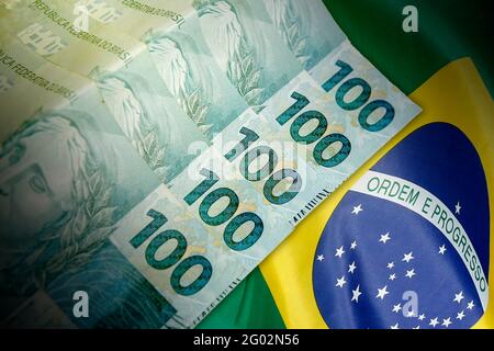 Brazilian money banknotes with Brazilian flag in the background Stock ...