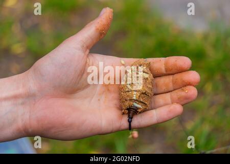 fishing on the river a man puts a bait for catching fish, selective ...