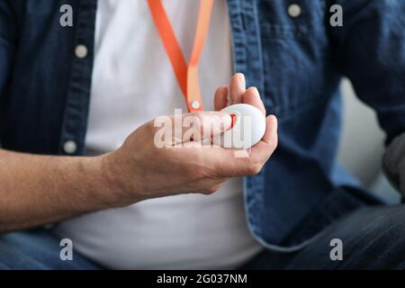 Unrecognizable old man pushing red button for emergency Stock Photo - Alamy