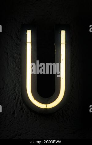 White neon letter U glowing in the dark Stock Photo - Alamy