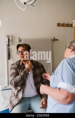 Young Asian female doctor examining anatomical brain model during ...