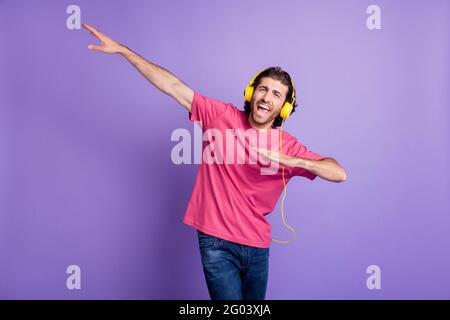 Cool eastern guy singing and dancing on blue, showing smartphone Stock ...