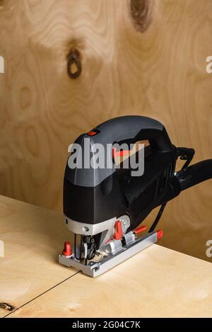 Electric jig saw cutting plywood Stock Photo - Alamy