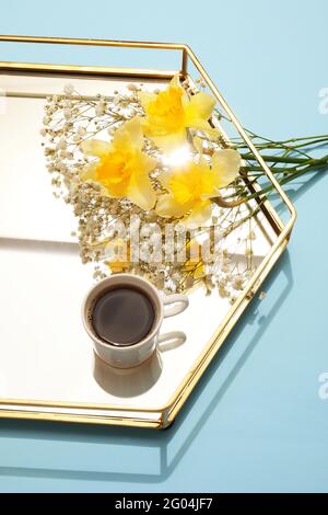 Tray with cup of coffee and beautiful gypsophila flowers on white ...