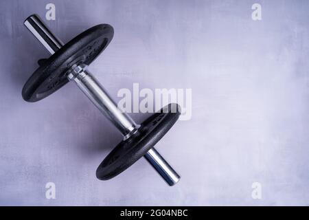Top view of collapsible dumbbells on a gray background Stock Photo - Alamy