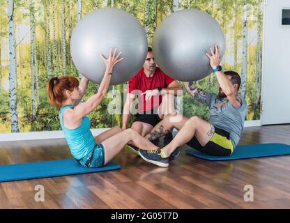 People doing crunches with pilates ball Stock Photo - Alamy