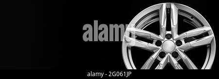 silver new alloy wheel with bifurcated beams on a black background ...