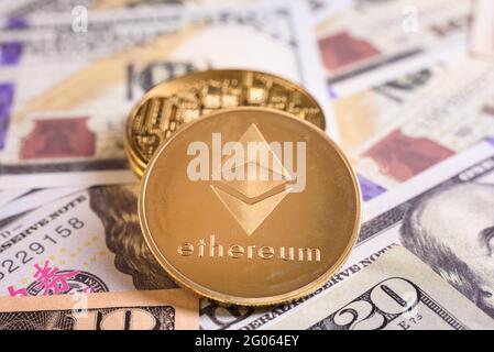 Ethereum real cryptocurrency on gold bars and US dollar bills Stock ...