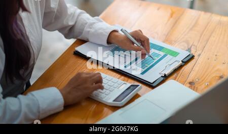 Financial Business woman analyze the graph of the company's performance ...
