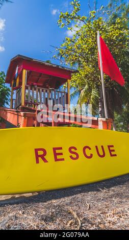 Tropical beach with red and yellow flag, Sri Lanka Stock Photo - Alamy