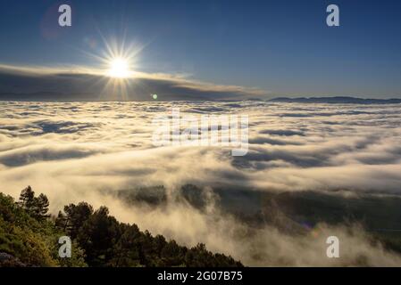 Foggy spring sunrise in Plana de Vic, seen from Sant Bartomeu del Grau ...