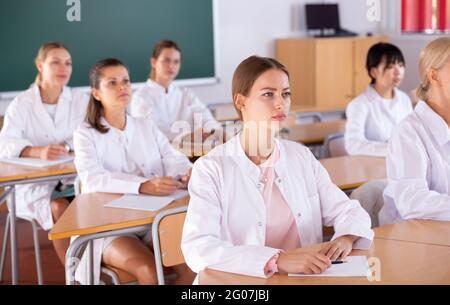 Group of young medical students doing research together in chemistry ...
