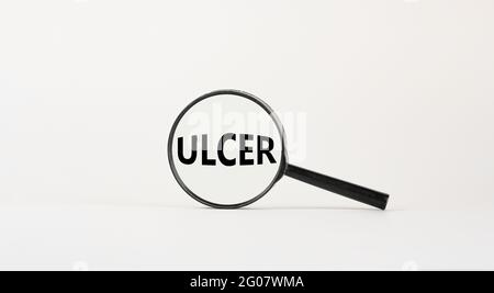 Medical and ulcer symbol. Magnifying glass with the concept word ulcer ...
